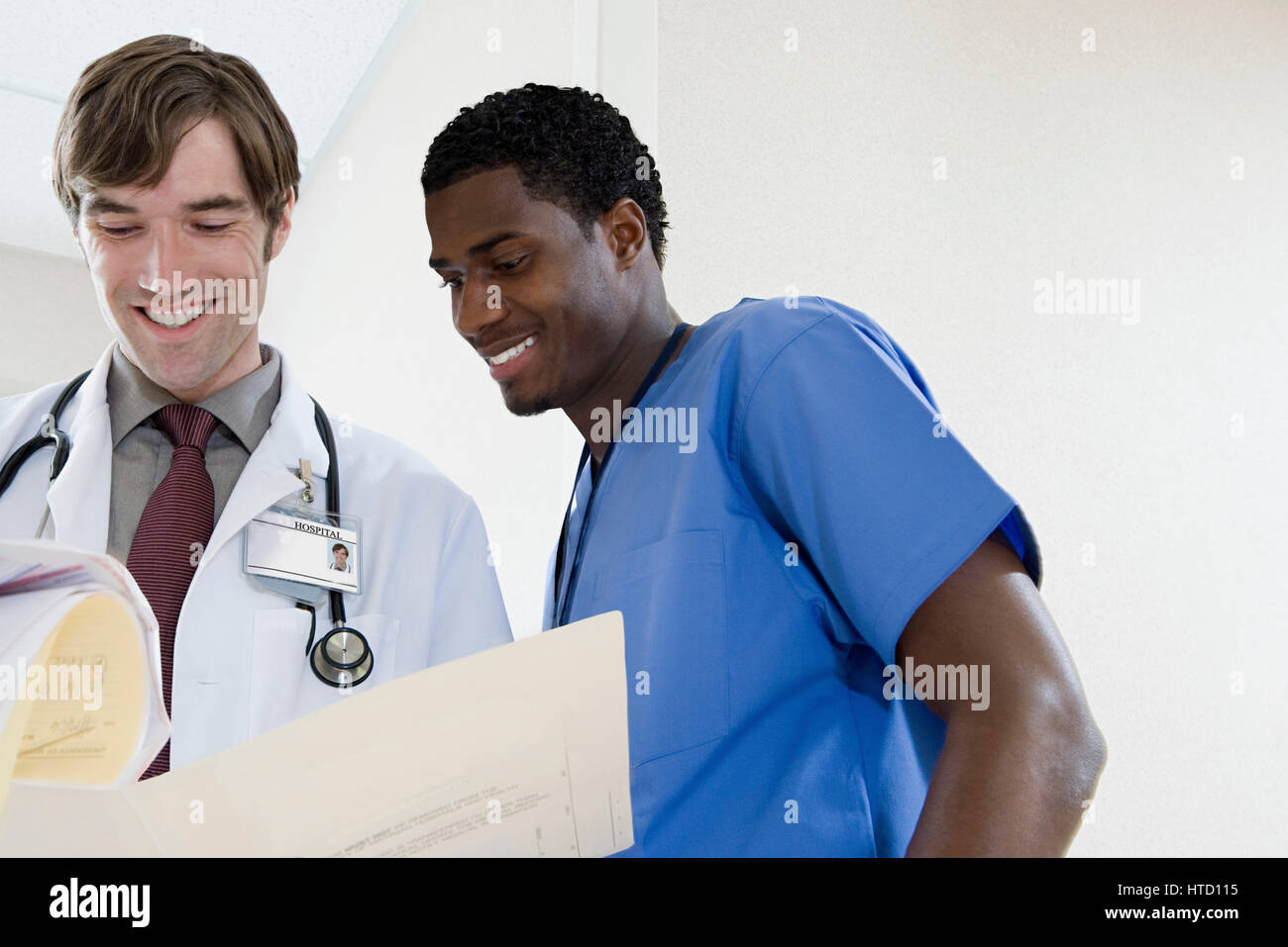 Doctor and nurse looking at paperwork Stock Photo - Alamy