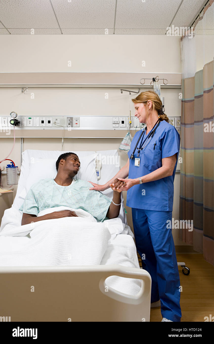 Doctor consoling patient Stock Photo - Alamy
