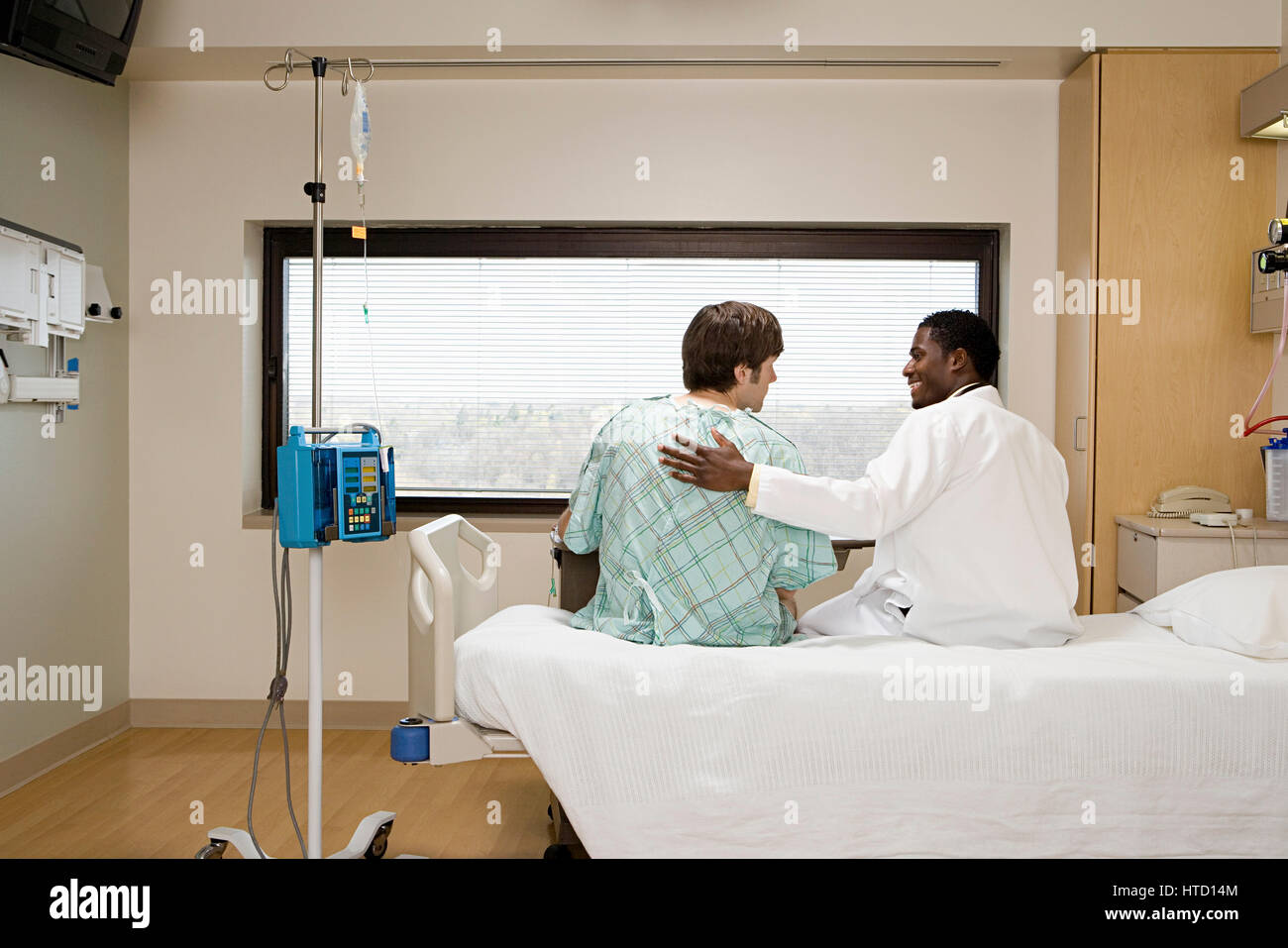 Doctor reassuring patient Stock Photo - Alamy