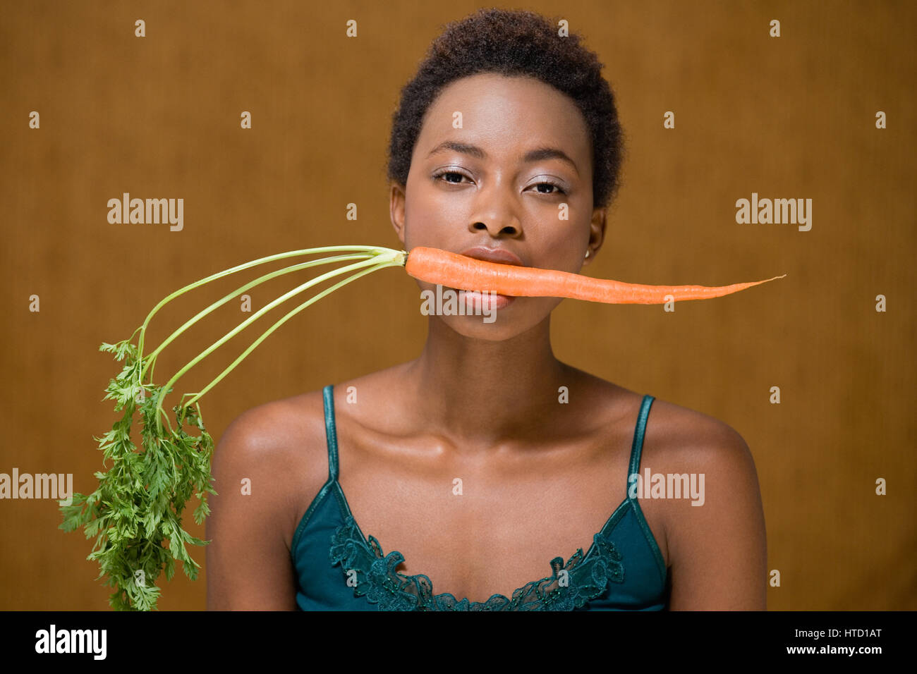 Young woman biting carrot hi-res stock photography and images - Alamy