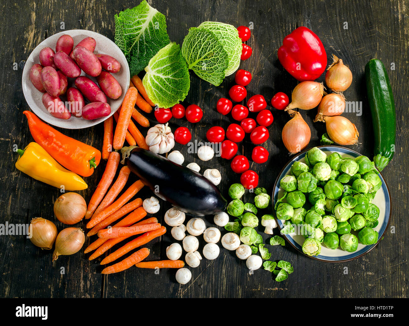 Organic fresh vegetables on a dark wooden table. Top view Stock Photo ...