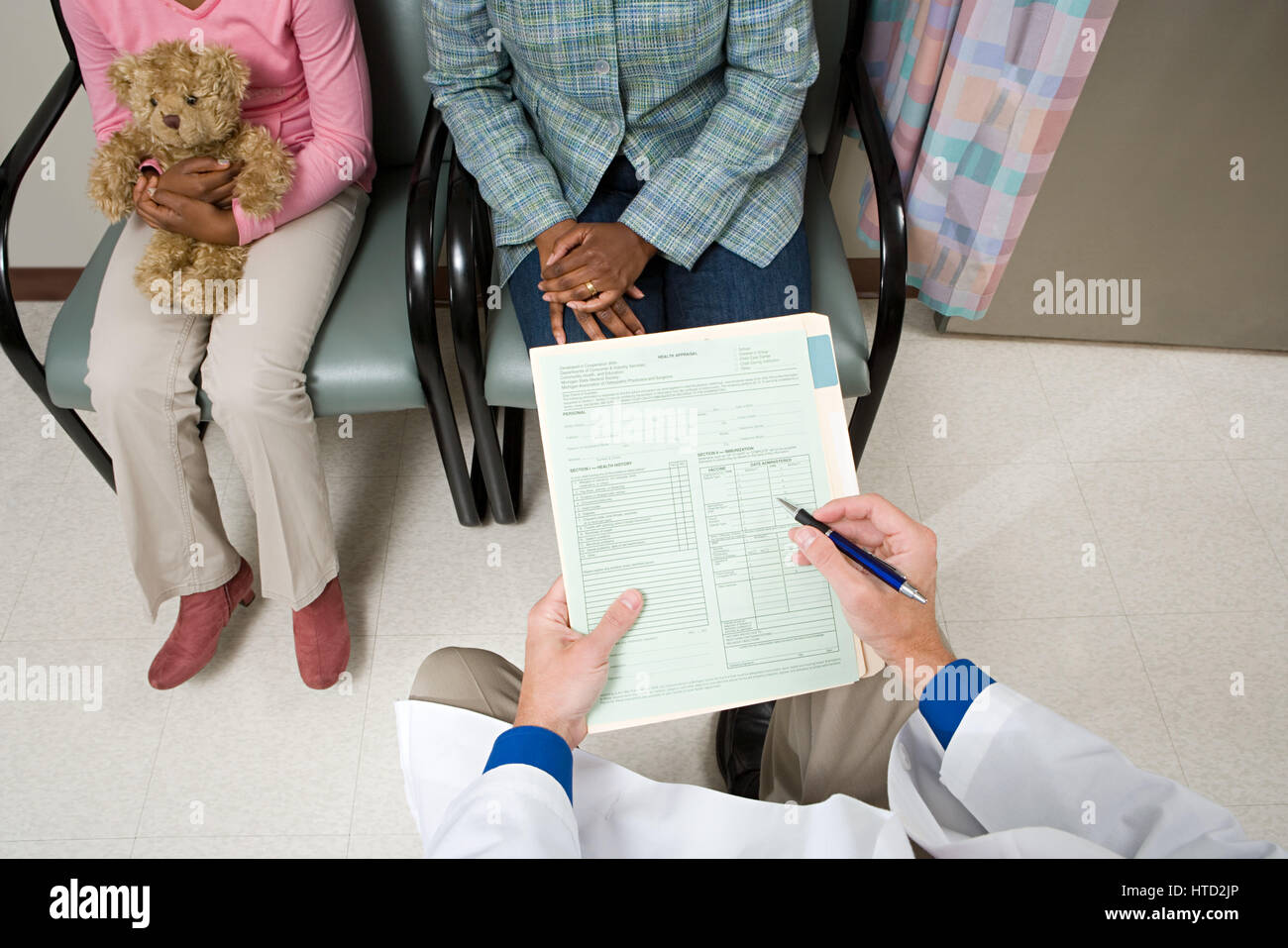 Doctor consulting parent and child Stock Photo - Alamy