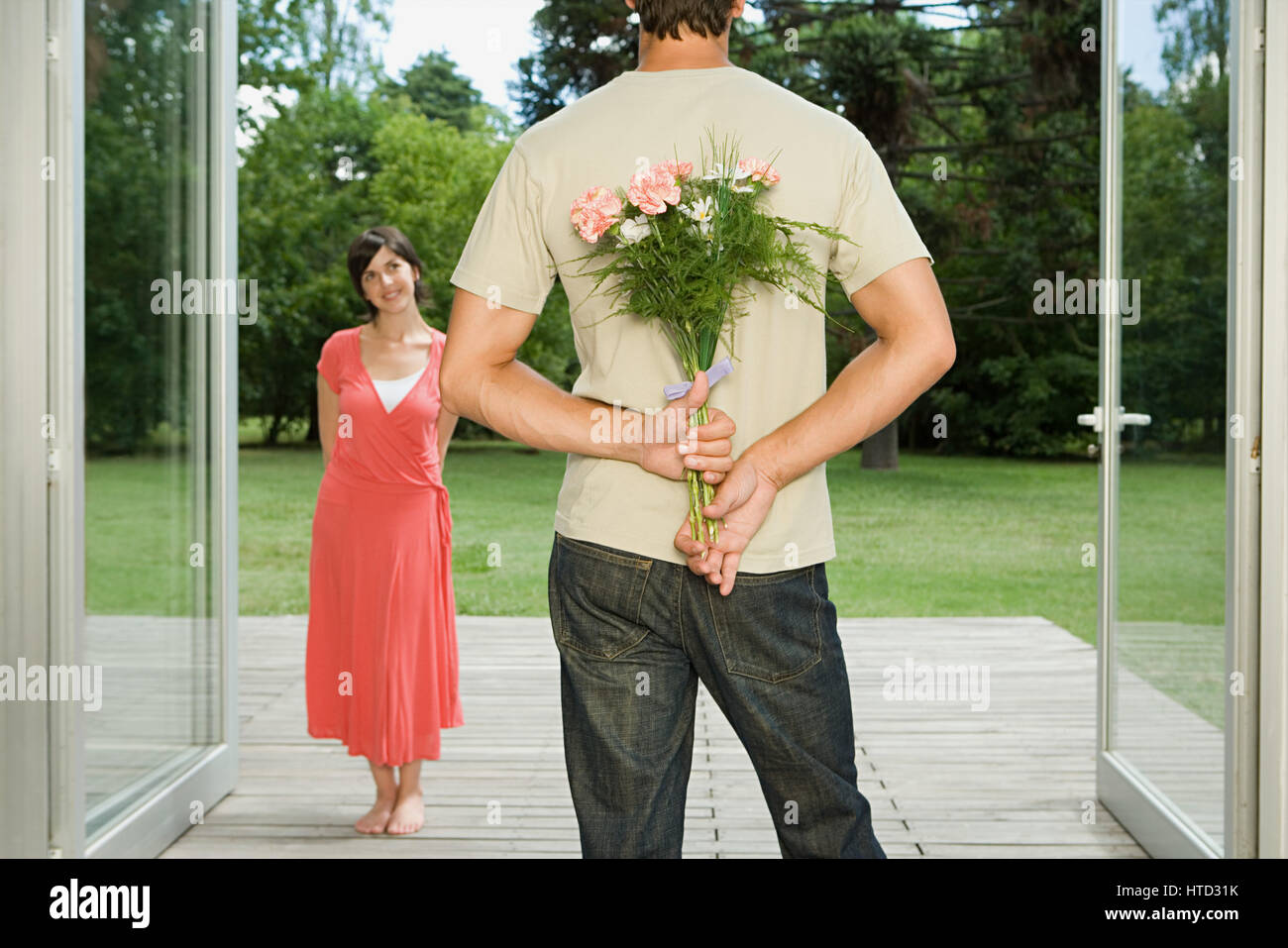 Woman surprising husband flowers hi-res stock photography and images ...