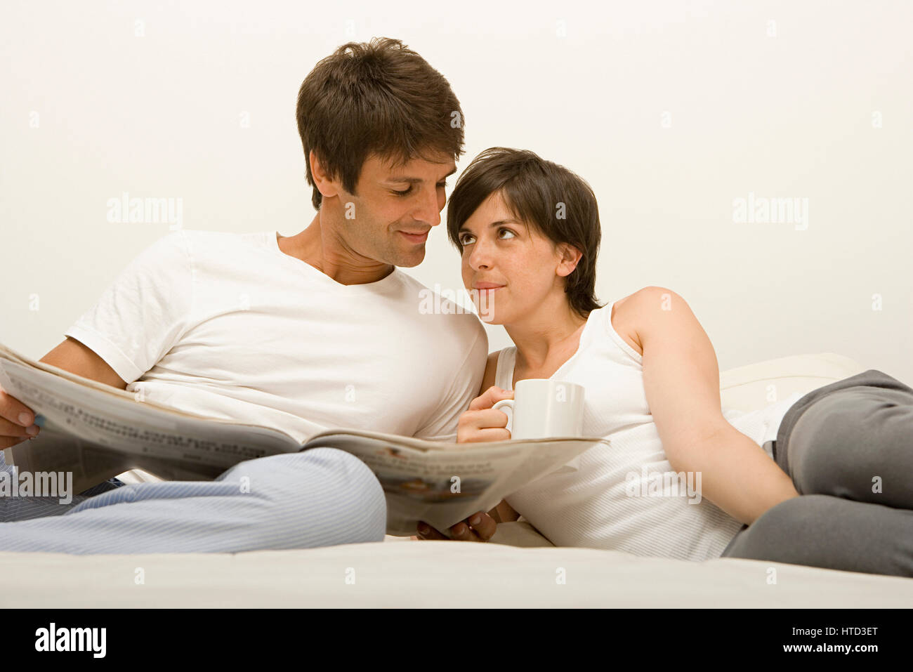 Couple reading newspaper Stock Photo - Alamy