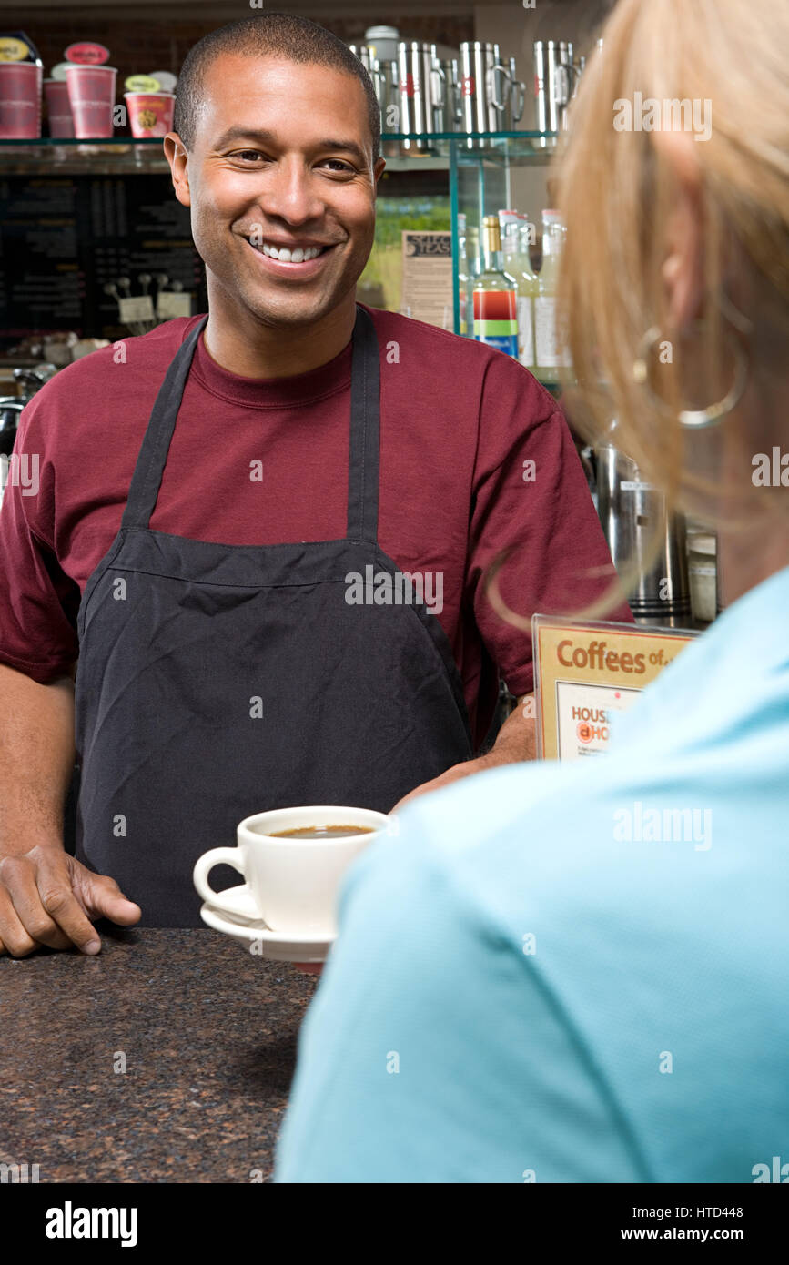 Waiter serving customer Stock Photo - Alamy