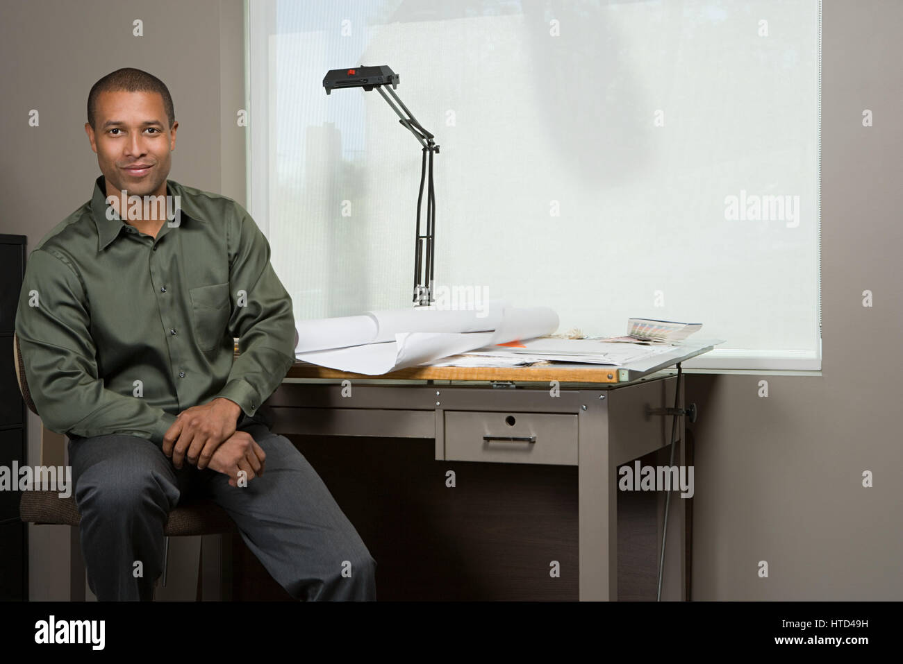 Concentrated architect holding drawing hi-res stock photography and ...