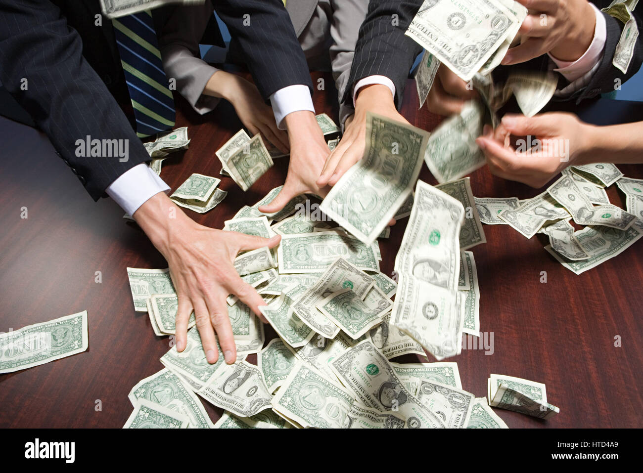 Businesspeople grabbing money Stock Photo - Alamy