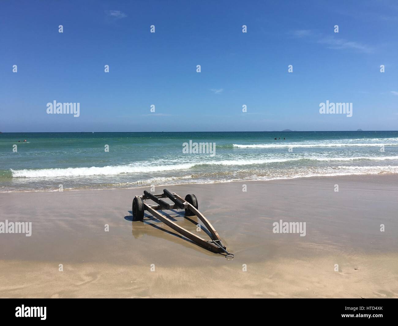 The wheelbarrow on the beach with sea wave foam Stock Photo - Alamy