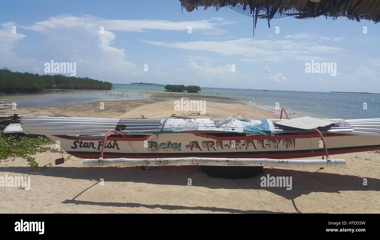 Traditional outrigger wooden fishing boat on the island, Philippines ...