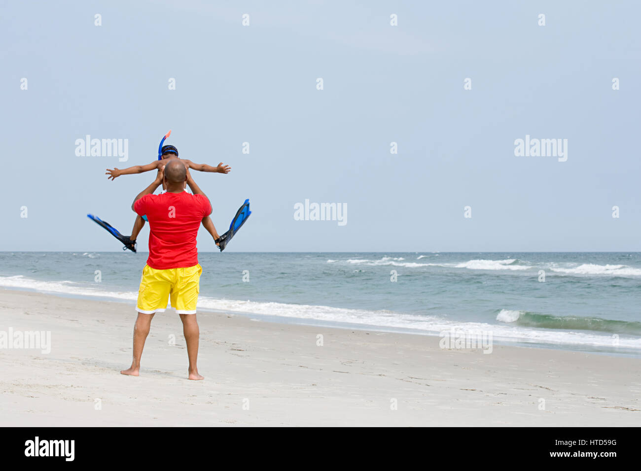 Father lifting son Stock Photo - Alamy