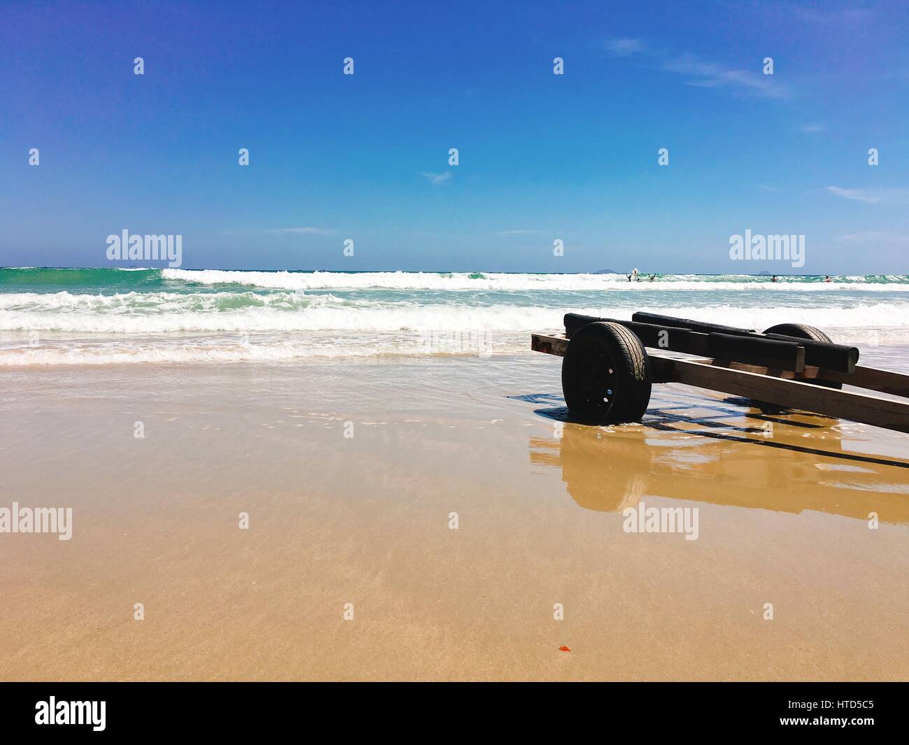 The wheelbarrow on the beach with sea wave foam Stock Photo - Alamy