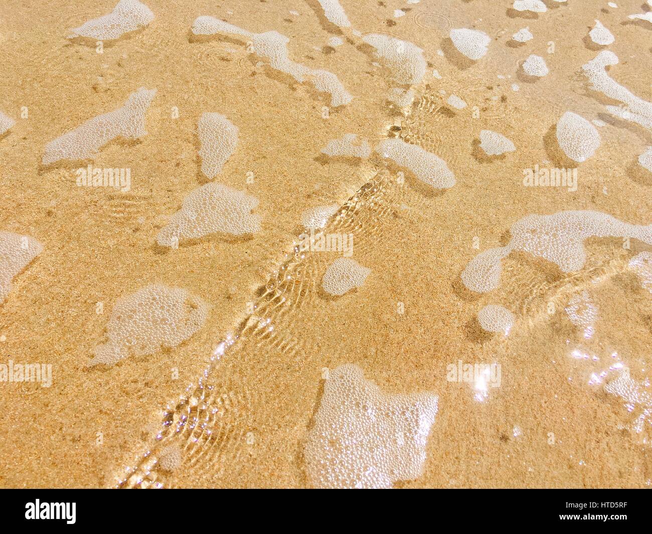 Sea waves reaching lapping to shore Stock Photo - Alamy