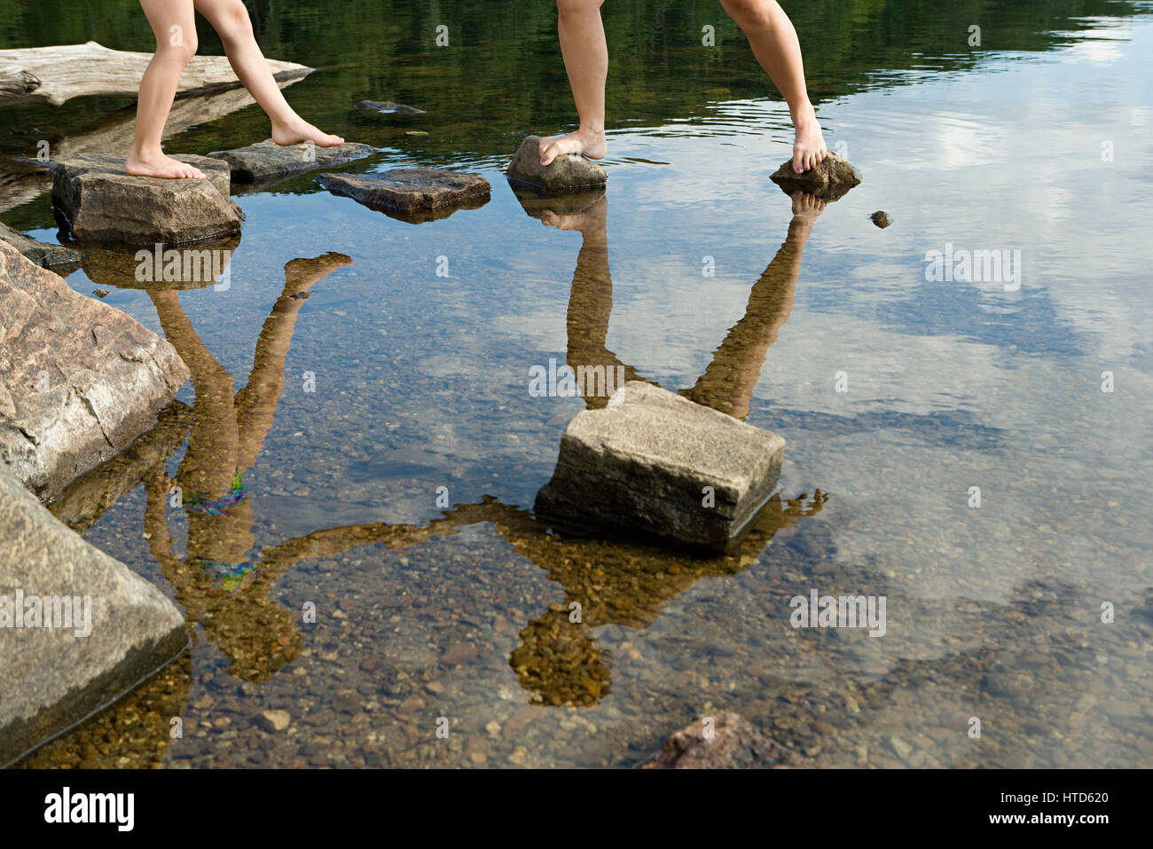 Standing on stepping stones Stock Photo - Alamy