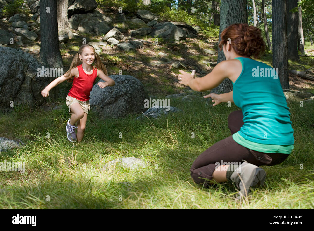 Girl running to mother Stock Photo - Alamy