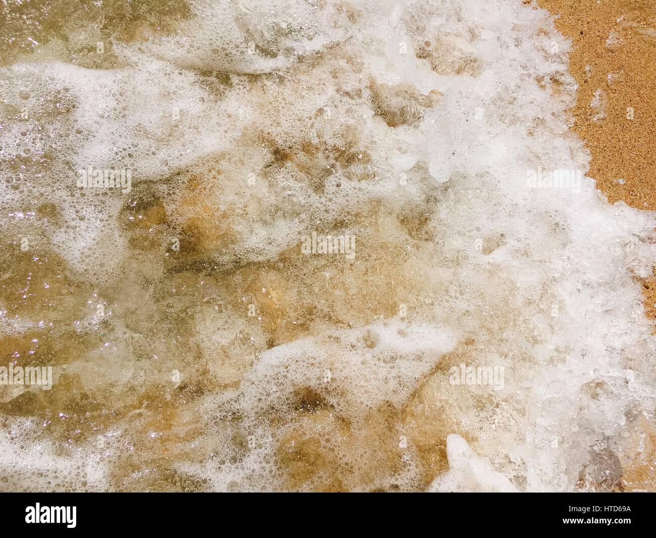 Sea waves reaching lapping to shore Stock Photo - Alamy