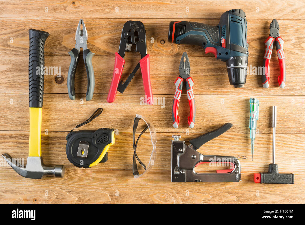 Variety of repair tools on wooden surface Stock Photo - Alamy