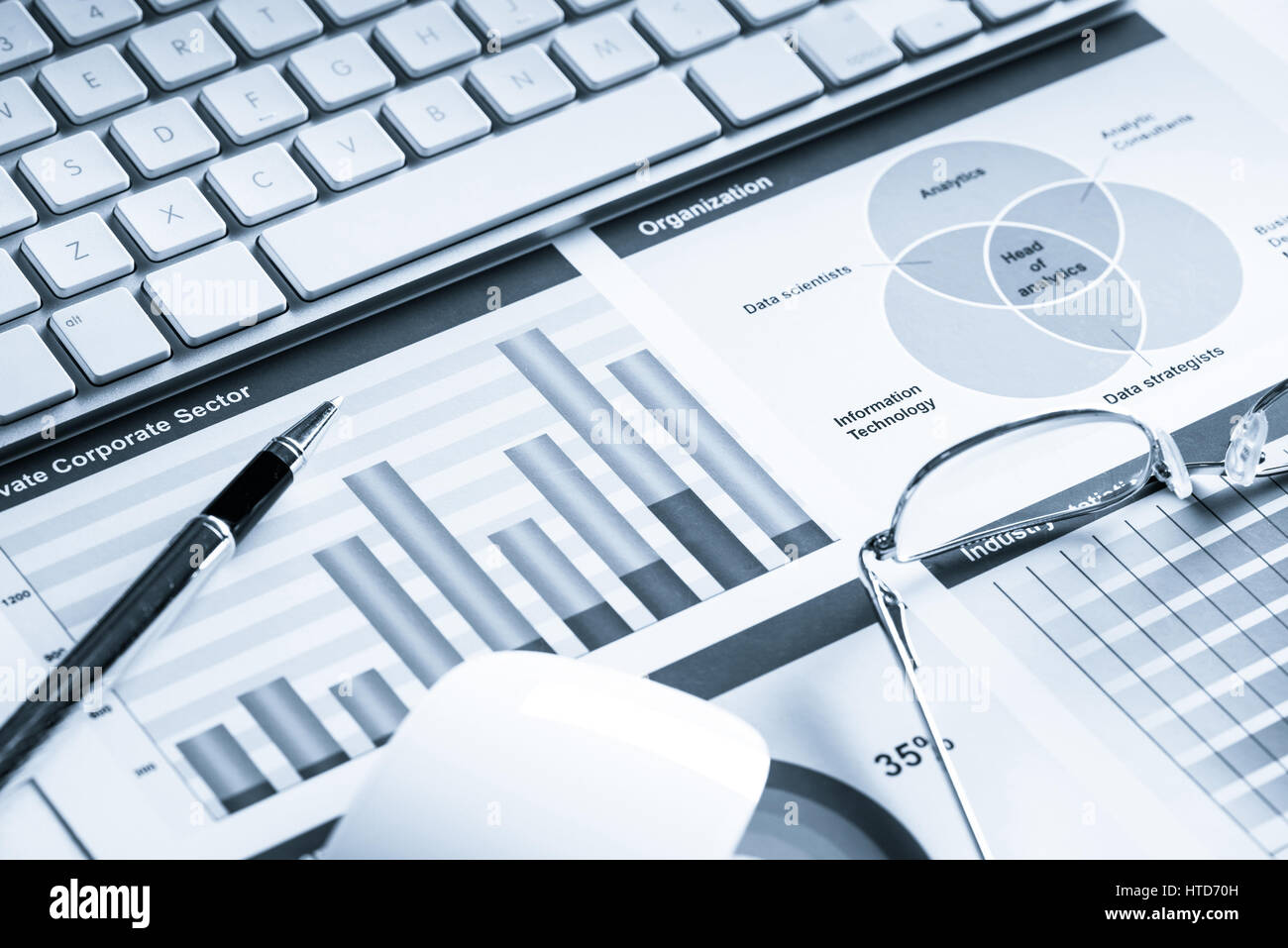 Business workplace with keyboard mouse and papers with graphs and ...