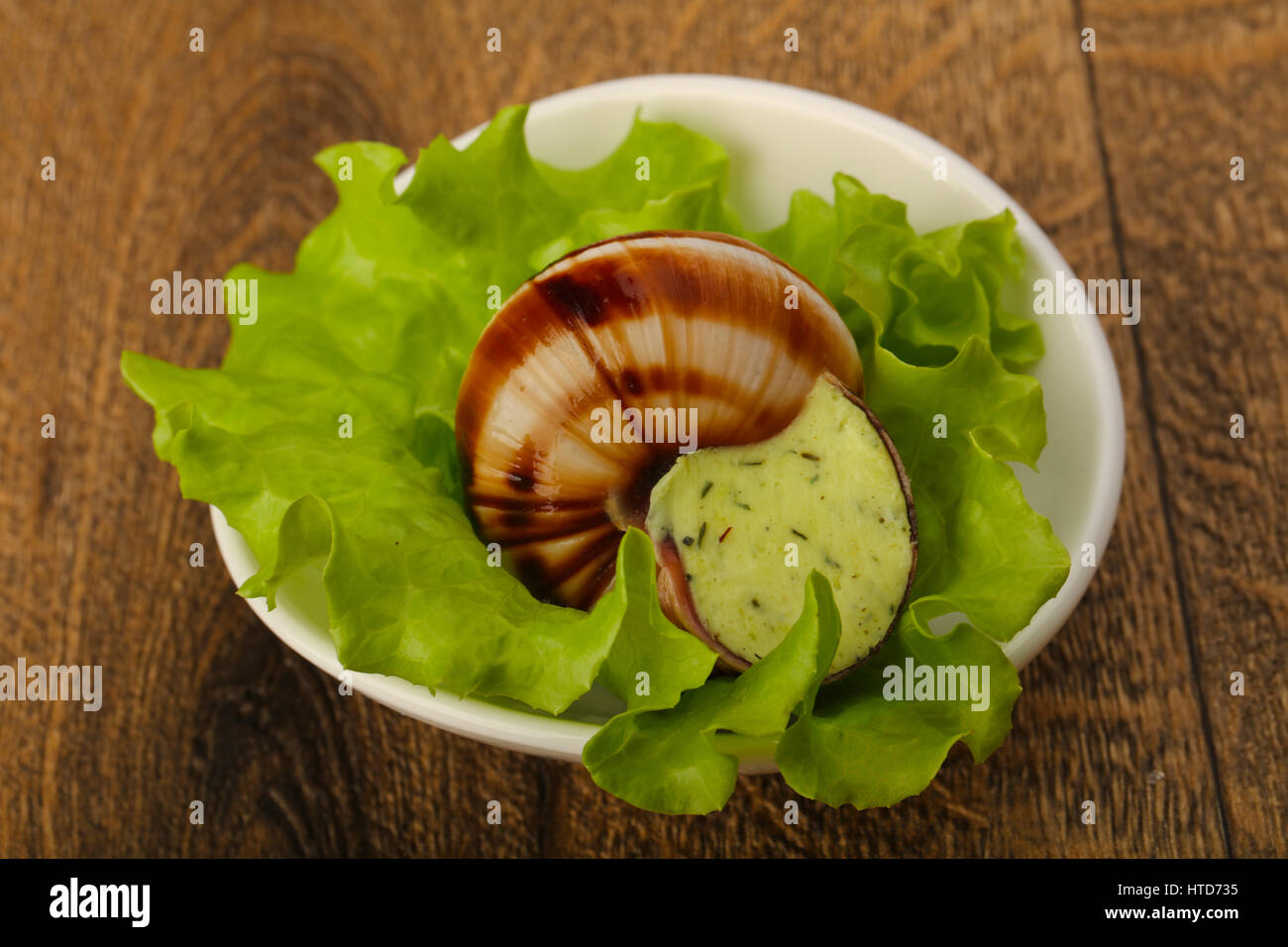 Escargot with cheese cream on salad leaves Stock Photo - Alamy