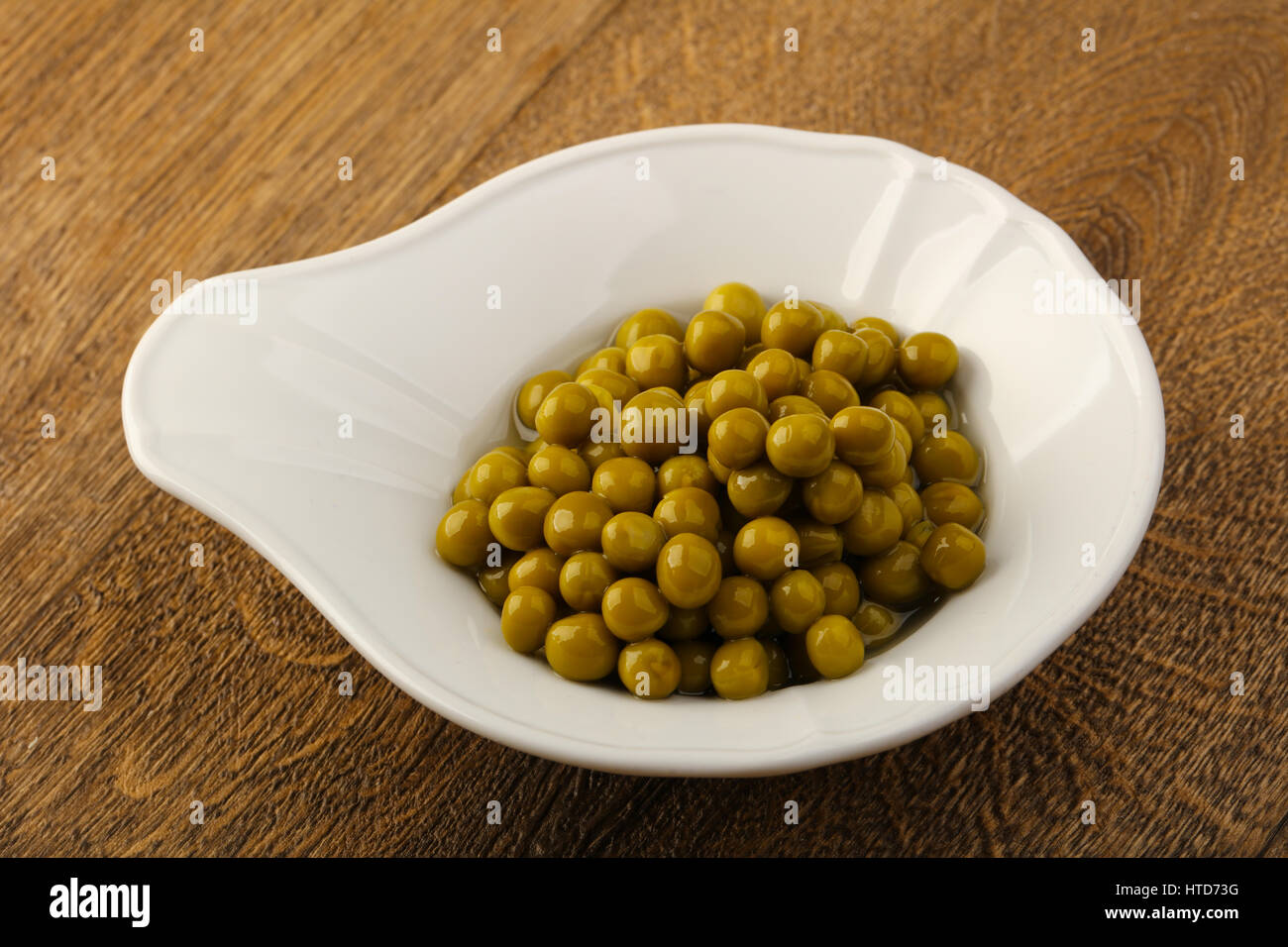 Pickled green pea on the wood background Stock Photo - Alamy