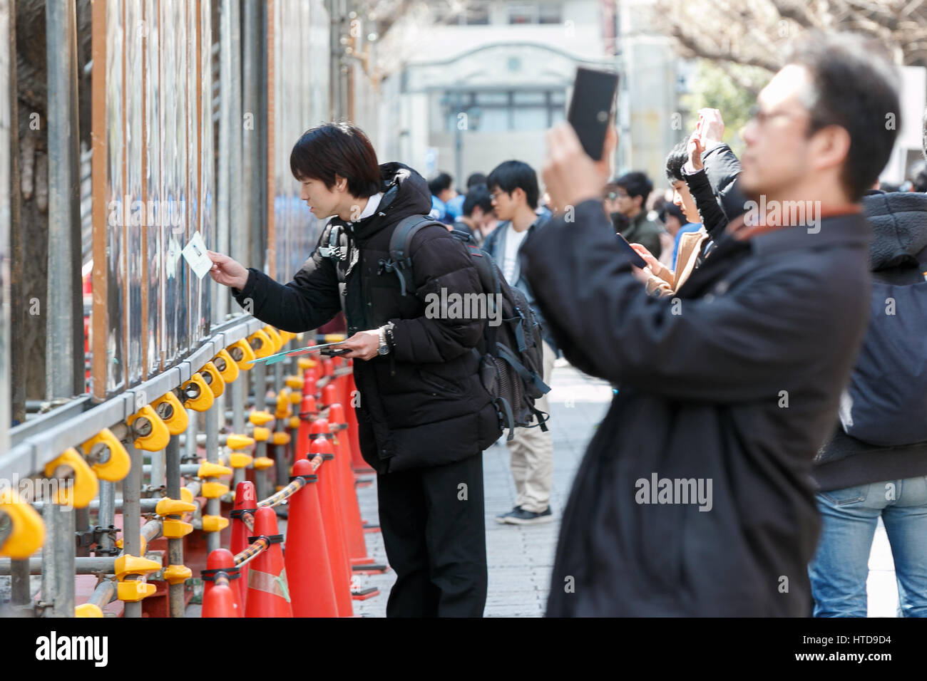 Japanese students look for their exam numbers on the list at the ...