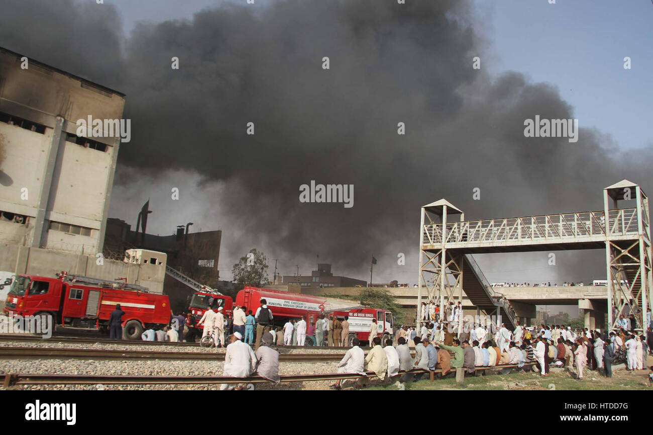 Fire fighter extinguishing erupted at denim factory located in Qazzafi ...