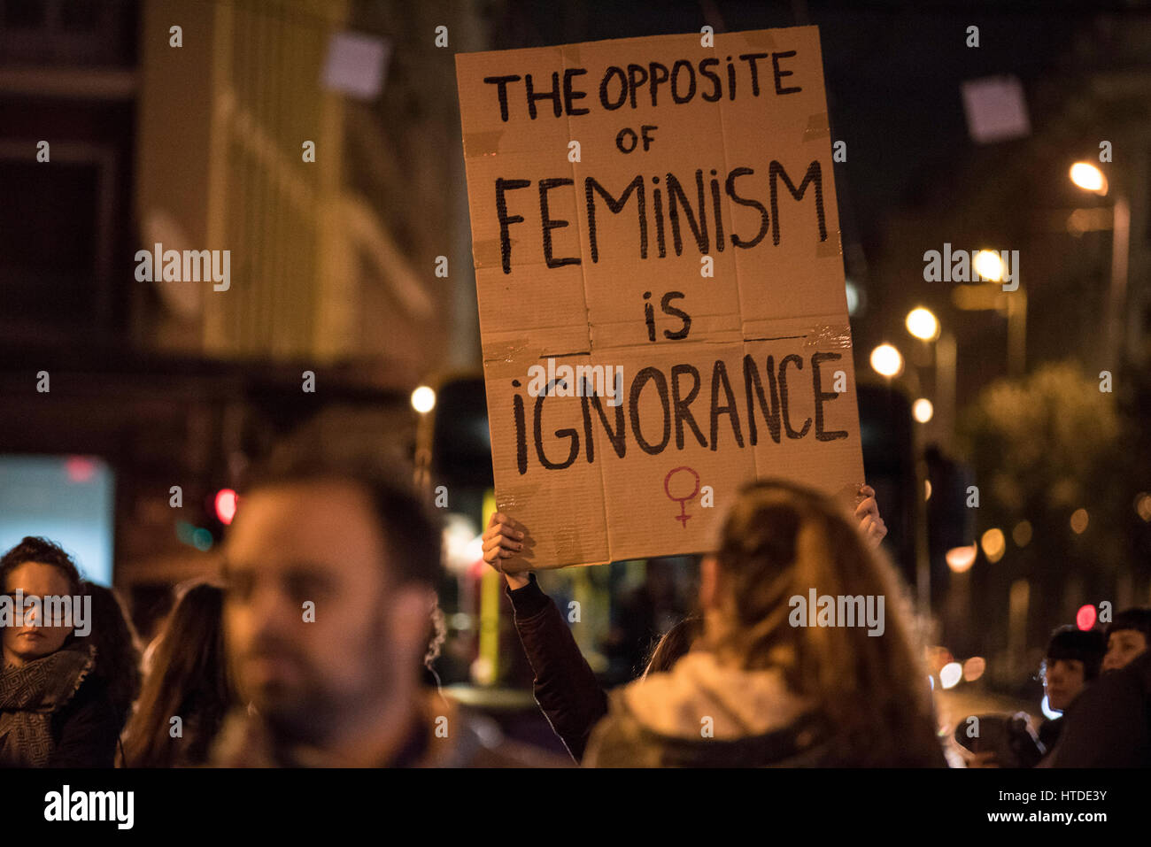 Women and men march in the streets of Athens shouting slogans and ...