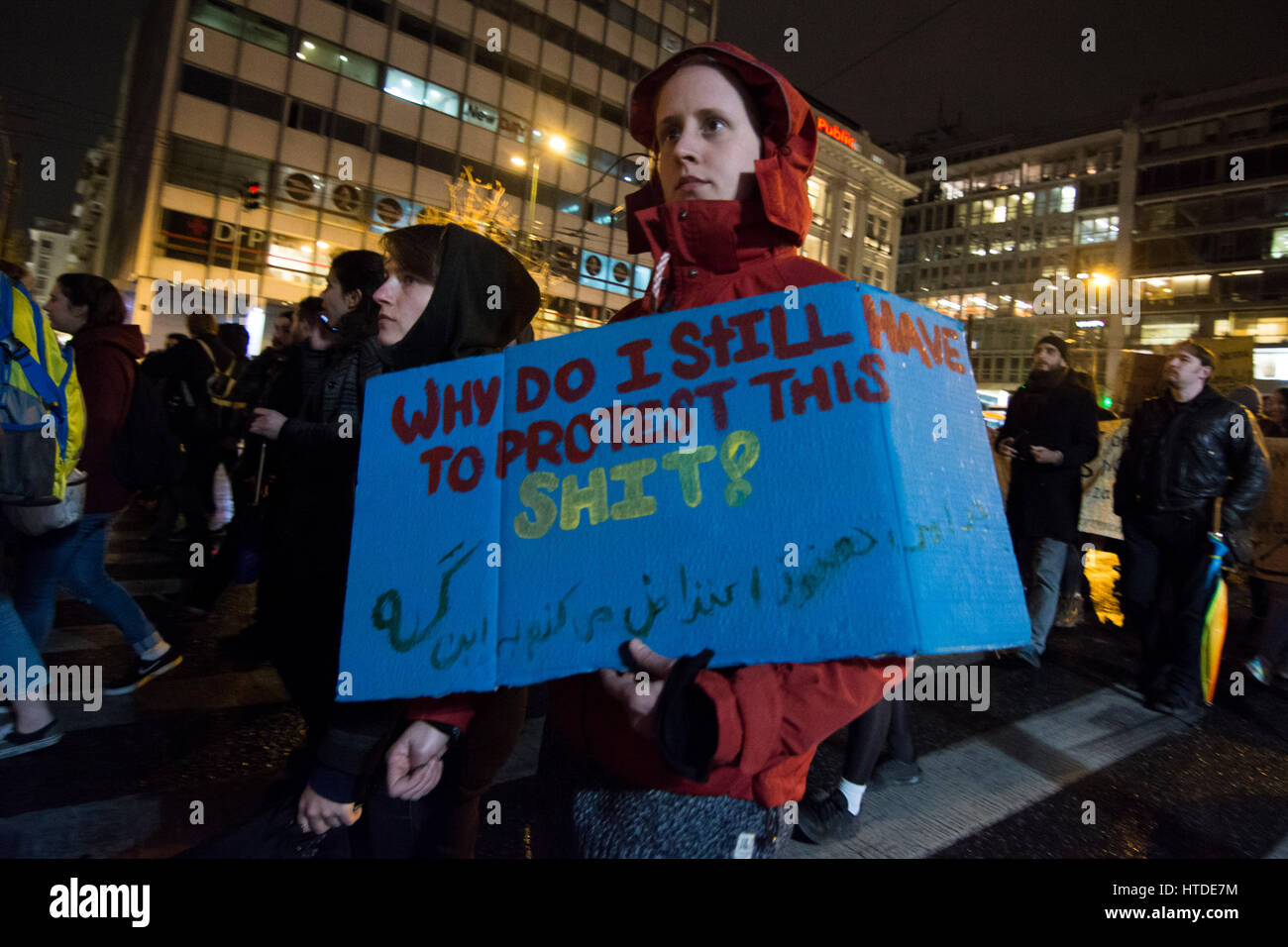 Women and men march in the streets of Athens shouting slogans and ...