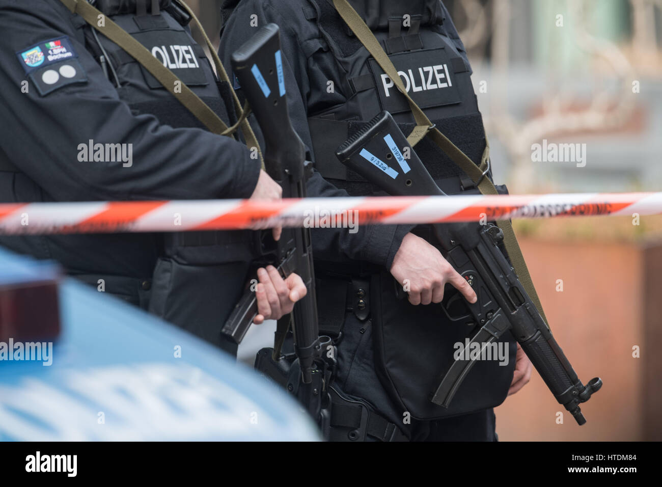 Essen, Germany. 11th Mar, 2017. Heavily armed Police officers secure a ...