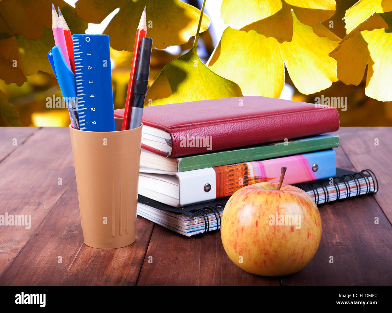 Stationery set and a stack of books on a wooden table Stock Photo - Alamy