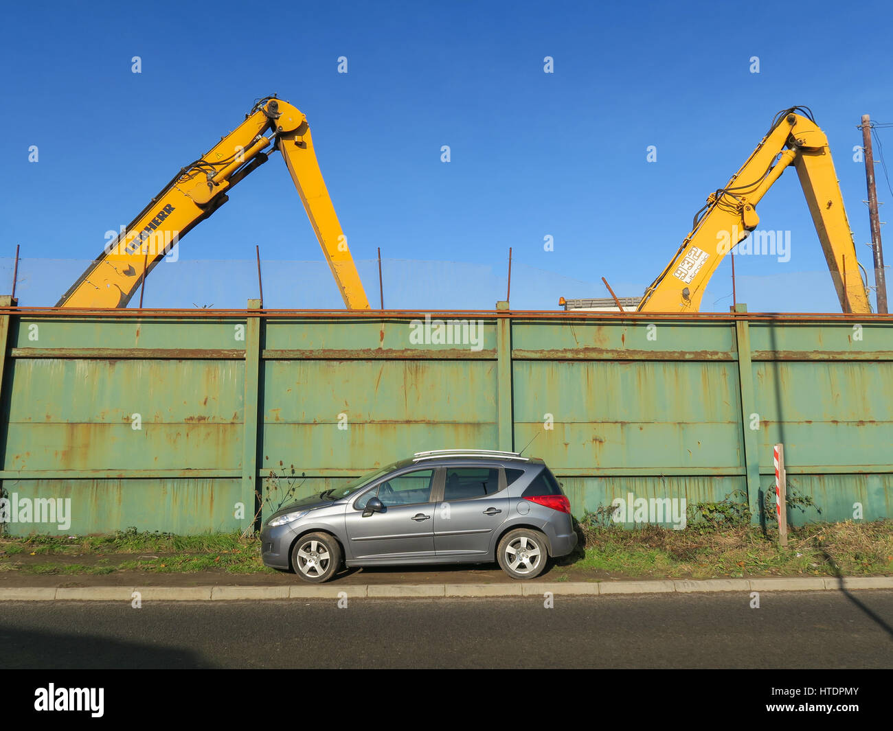yellow digger on a building site doing construction work Stock Photo ...