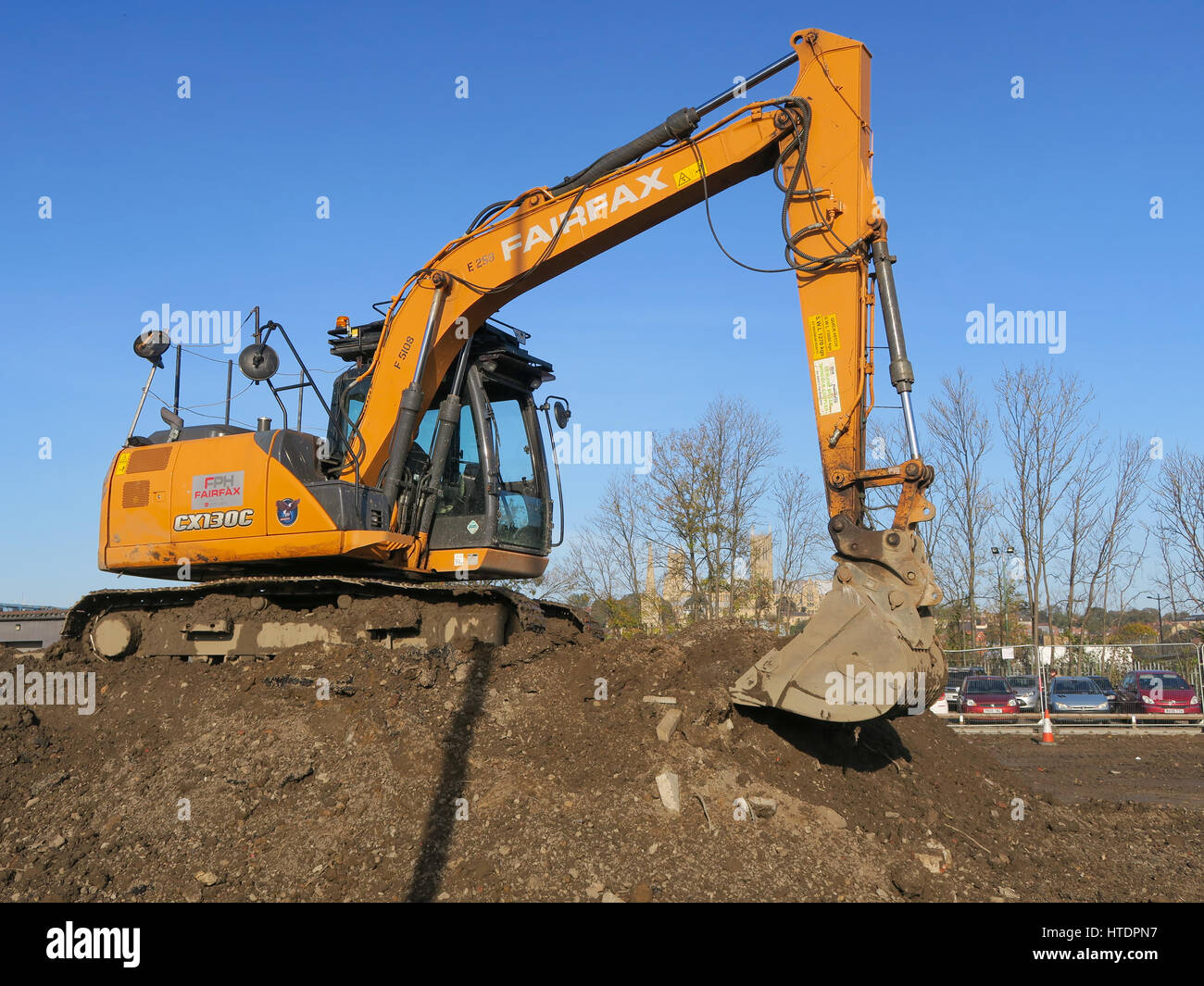 yellow digger on a building site doing construction work Stock Photo ...