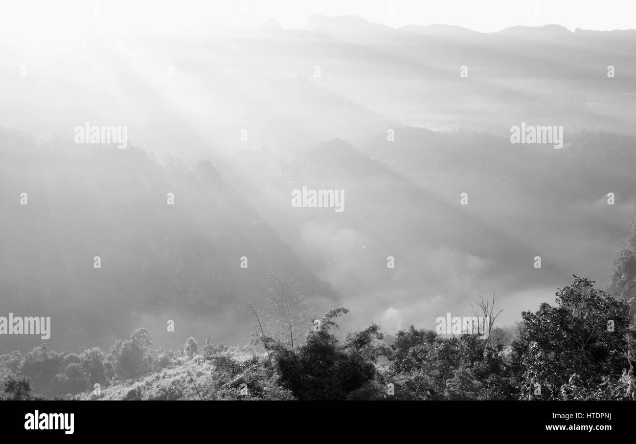 Sunrise over the mountain landscape with beautiful sun rays and low ...
