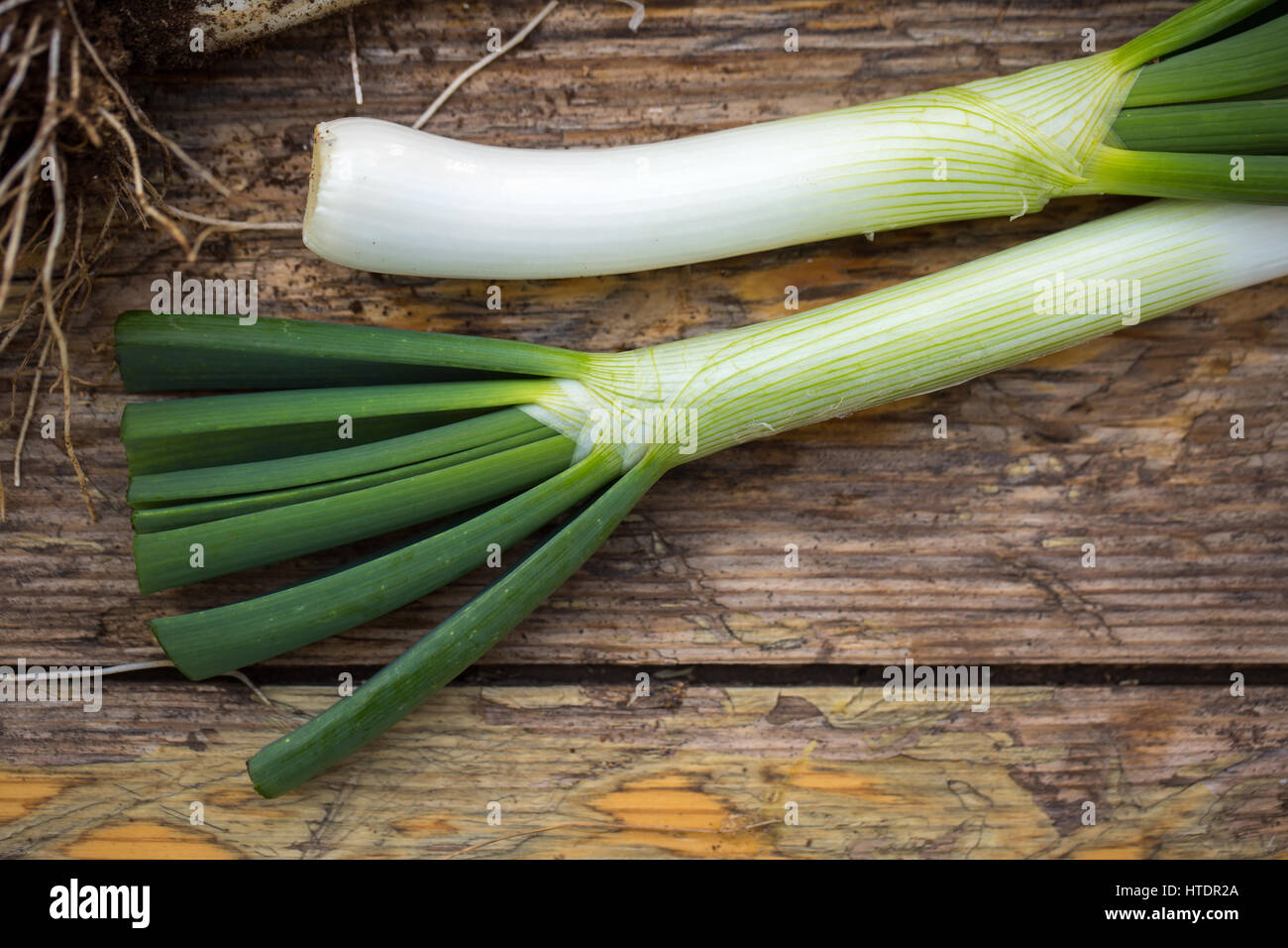 Fresh raw spring onions on a wooden board Stock Photo - Alamy