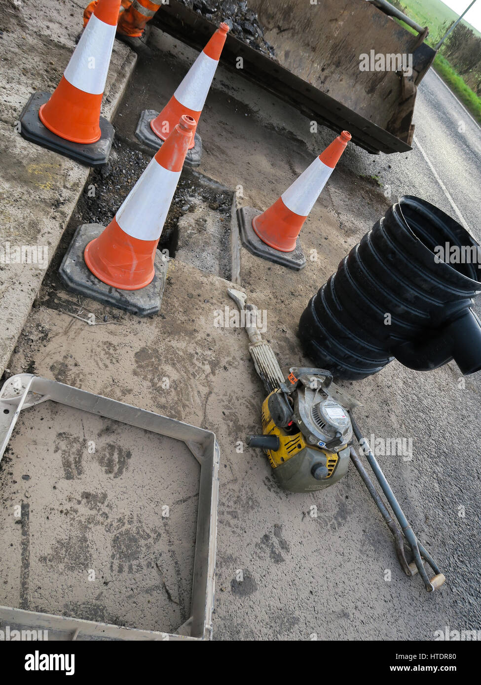 roadworks new gully and frame pot with traffic cones surrounding Stock ...