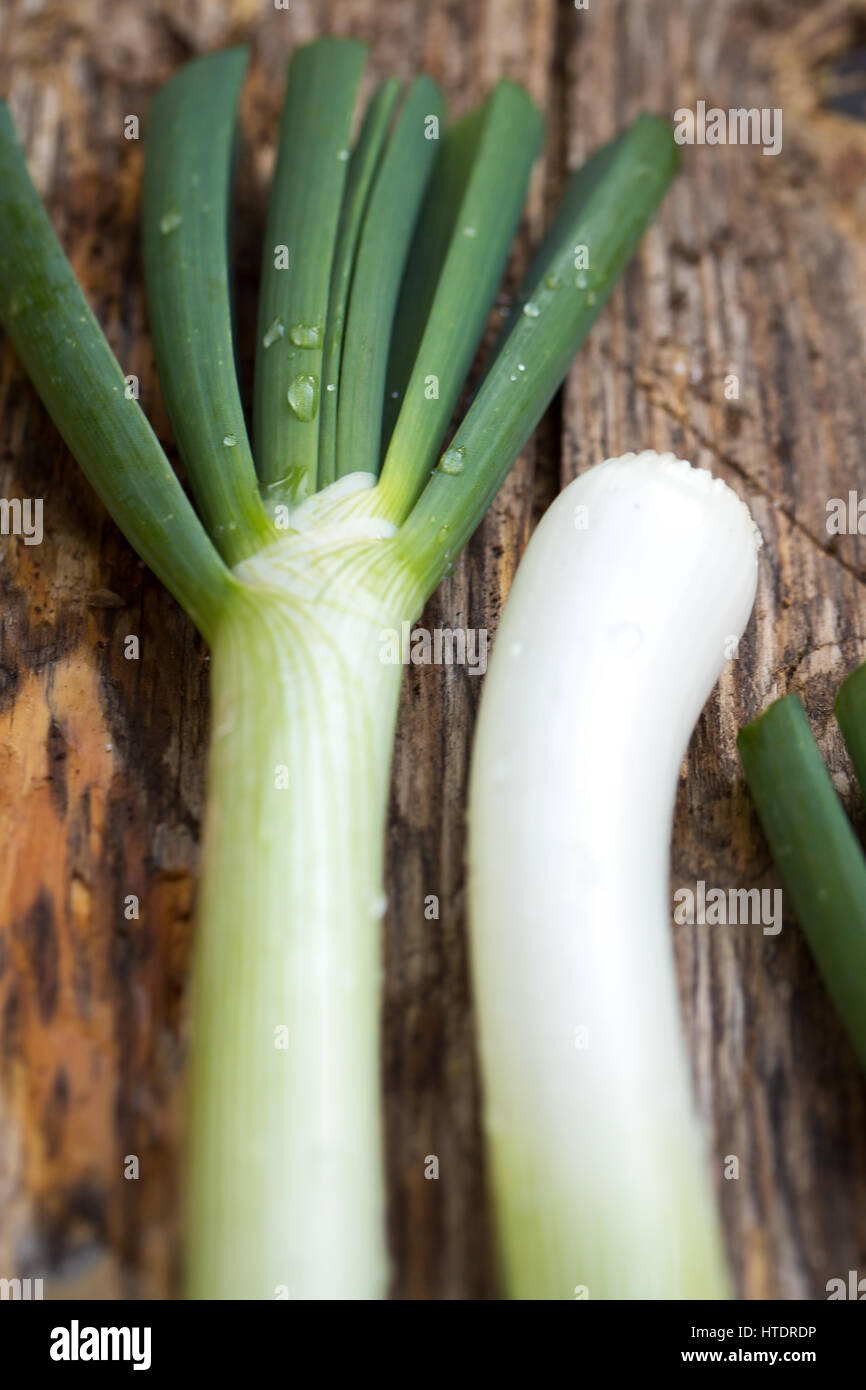 Fresh raw spring onions on a wooden board Stock Photo - Alamy
