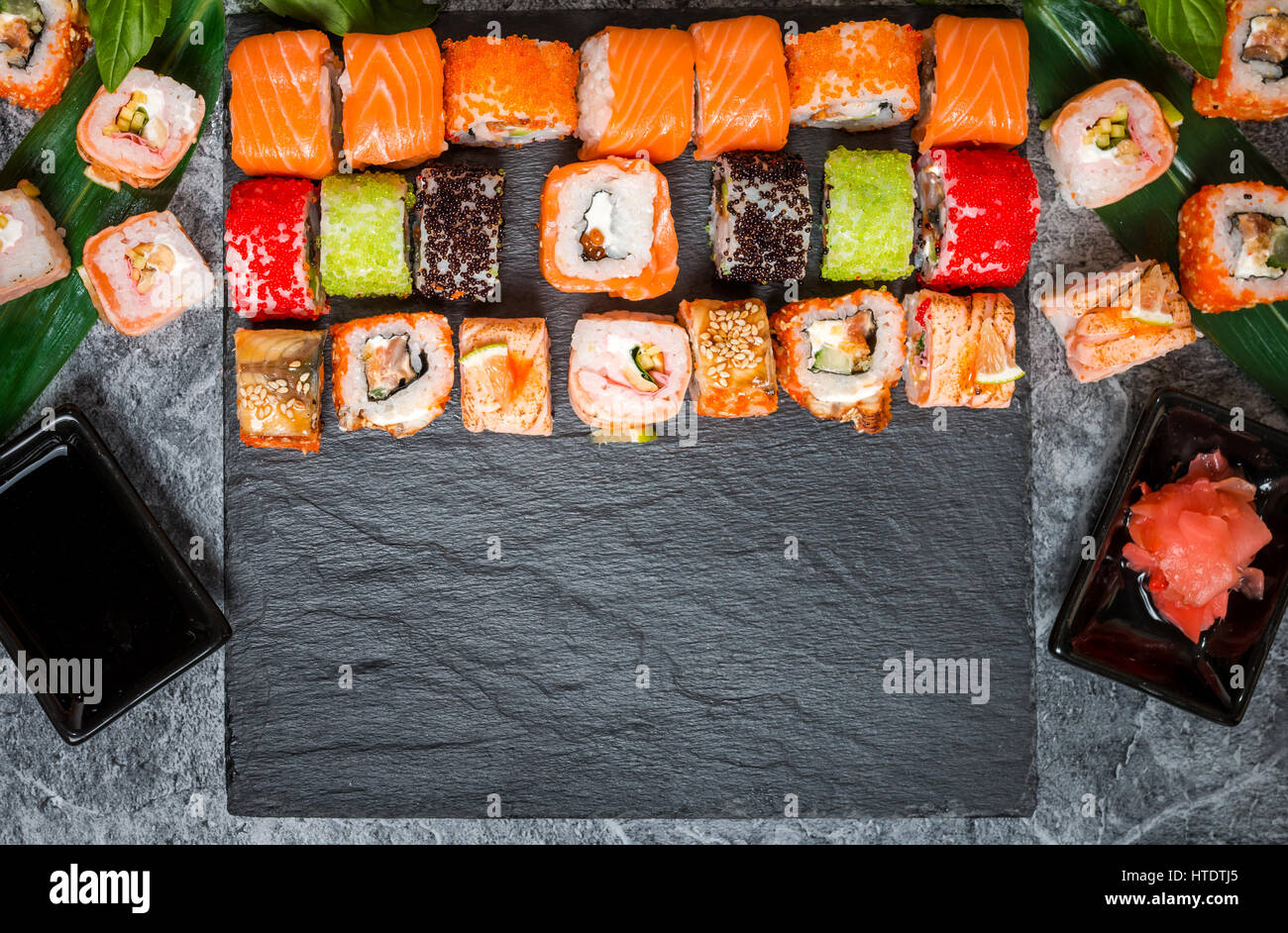 Traditional Japanese food - sushi, rolls and sauce on grey metal ...