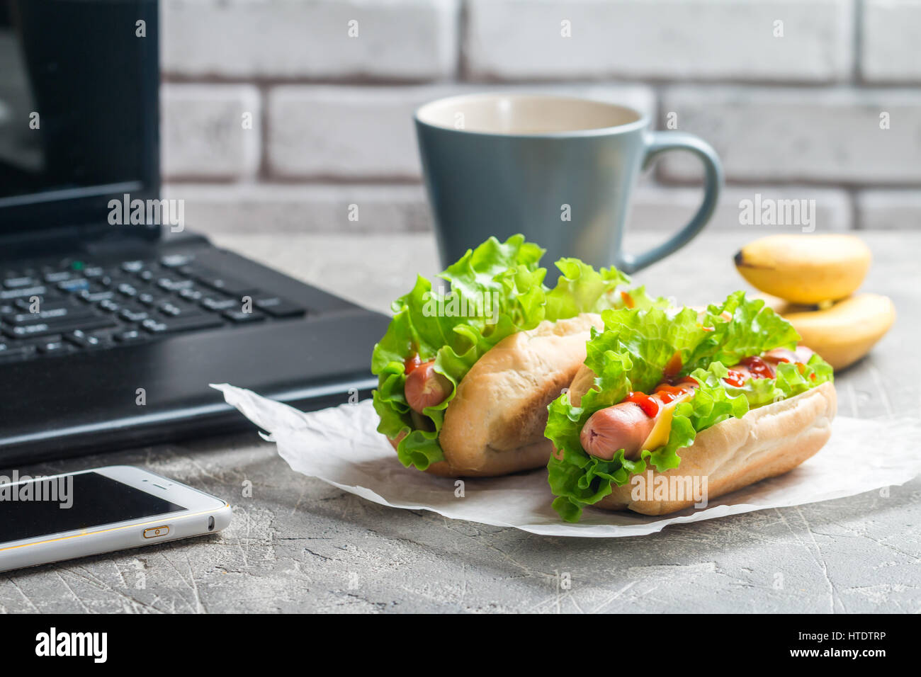 quick lunch of hotdog in the office near the laptop Stock Photo - Alamy