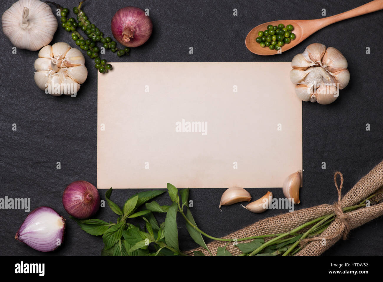 Vegetable recipe. Open menu book with fresh herbs and spices on dark ...