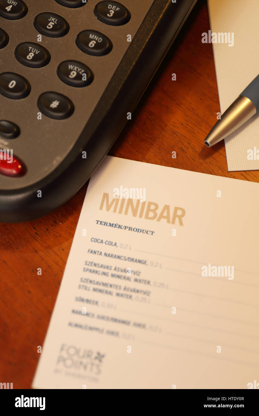 Hotel room mini bar menu with phone and pen Stock Photo - Alamy