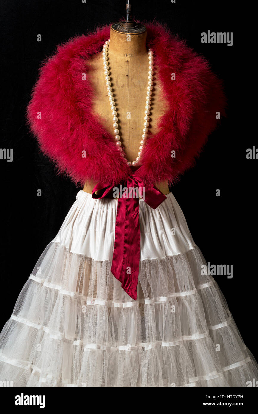 Red fur wrap and white net skirt on a mannequin Stock Photo - Alamy