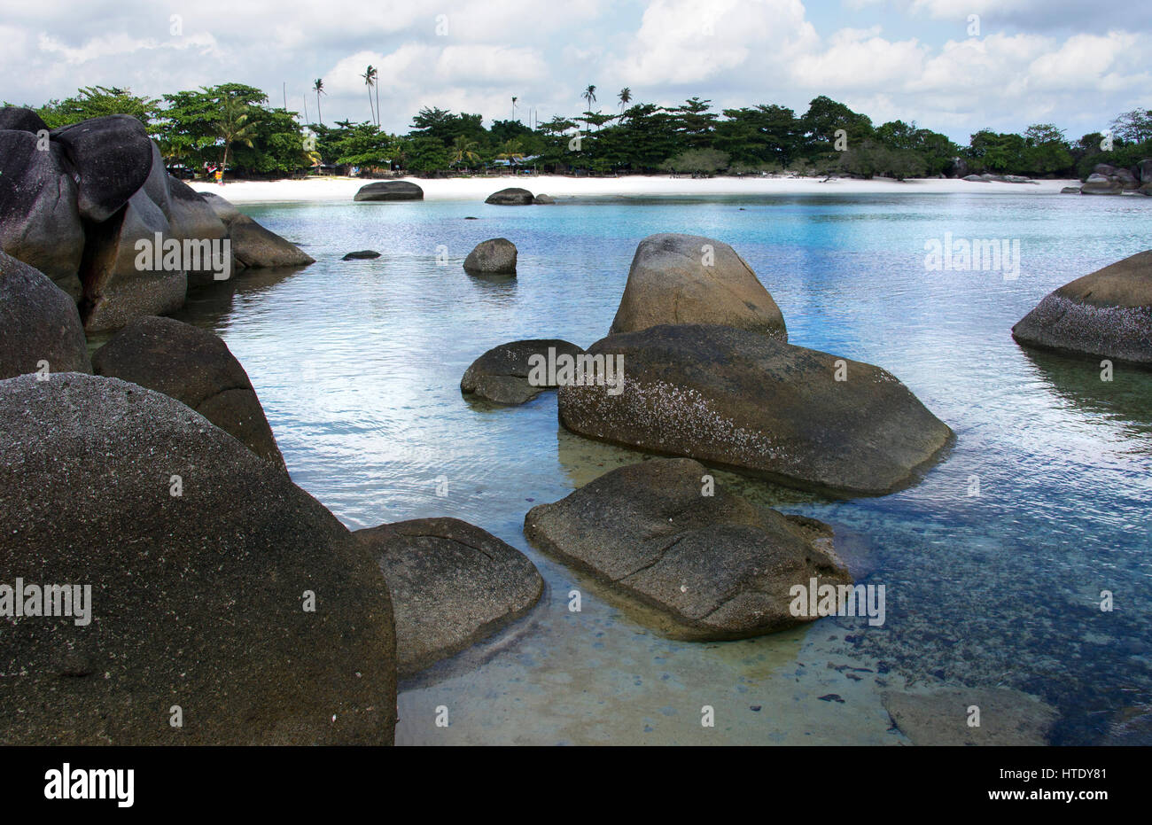 Natural rock formation in the sea and on a white sand beach in Belitung ...