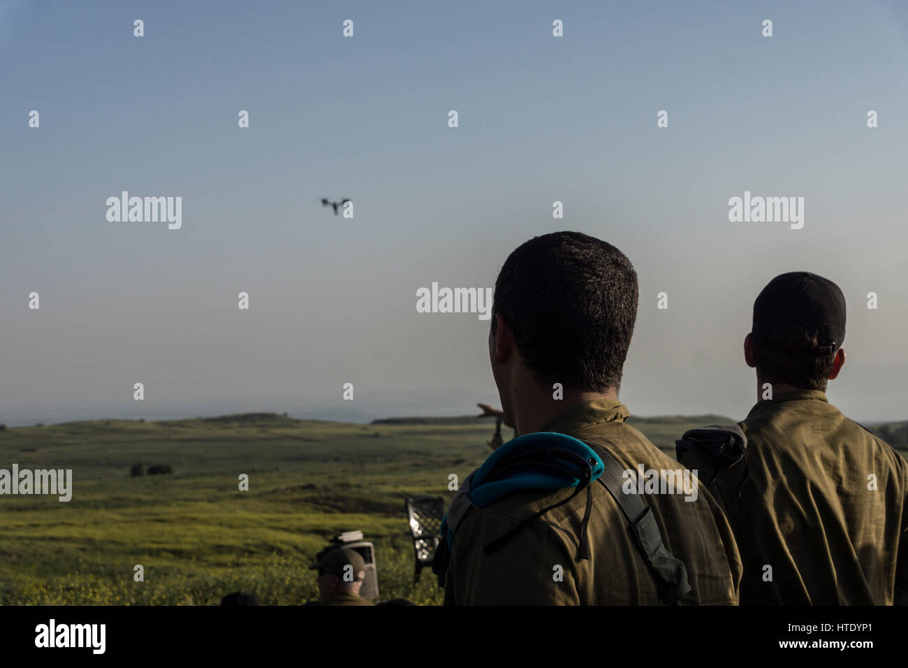 Golan Heights, Israel. Israeli soldiers look at a drone flying over a ...