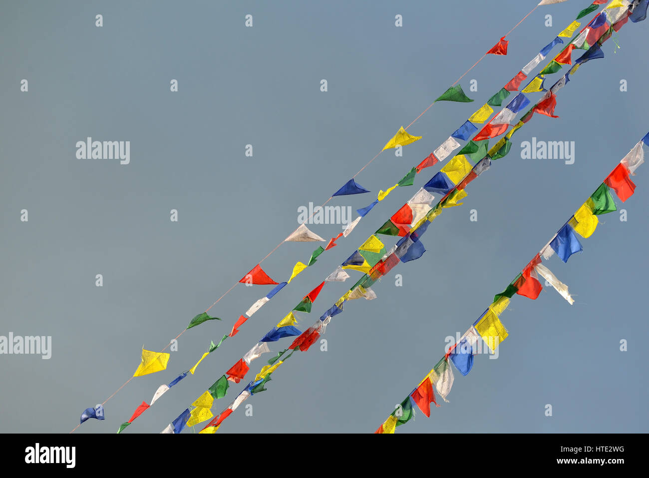 Buddhist Tibetan prayer flags blowing in the wind Stock Photo - Alamy