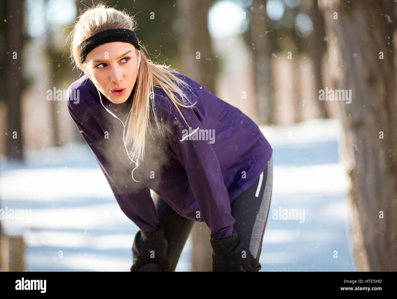 Athlete female stopped running to rest Stock Photo - Alamy