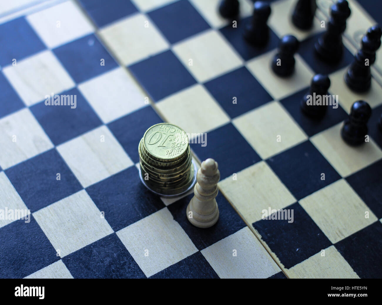 Picture of a chess board with stack of coins as the king Stock Photo ...