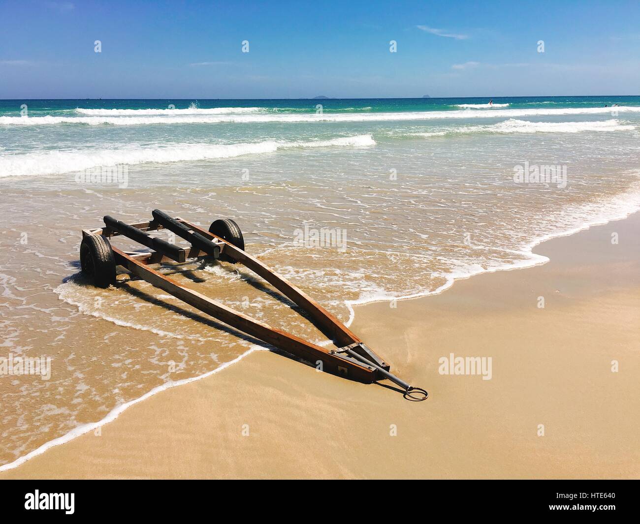 The wheelbarrow on the beach with sea wave foam Stock Photo - Alamy