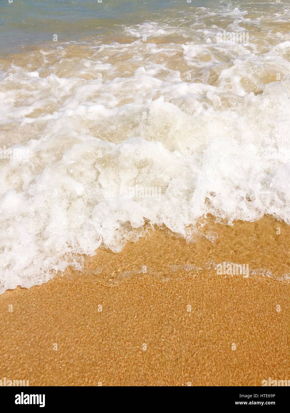 Sea waves reaching lapping to shore Stock Photo - Alamy