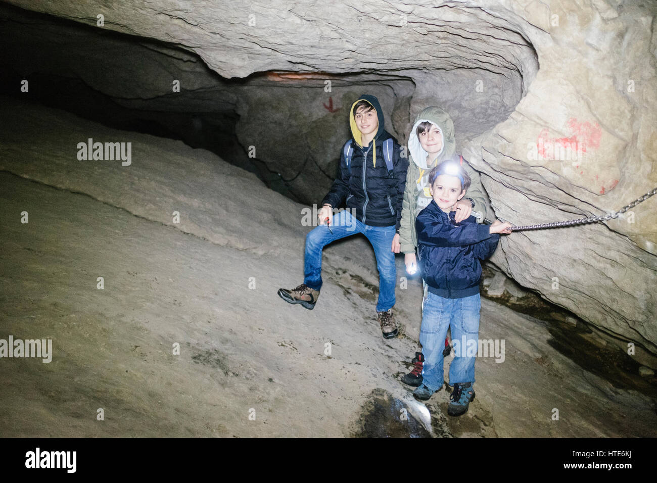Children explore underground cavern Stock Photo - Alamy