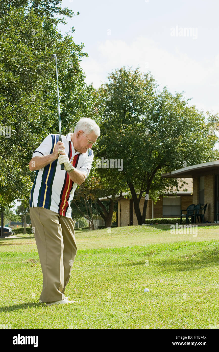 Senior man playing golf Stock Photo - Alamy