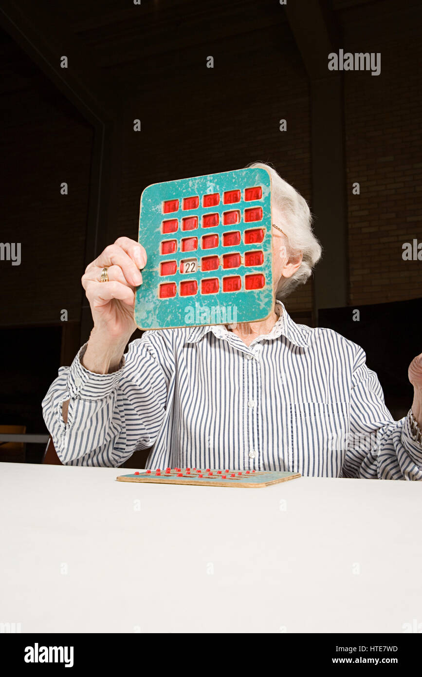 Senior woman playing bingo Stock Photo - Alamy